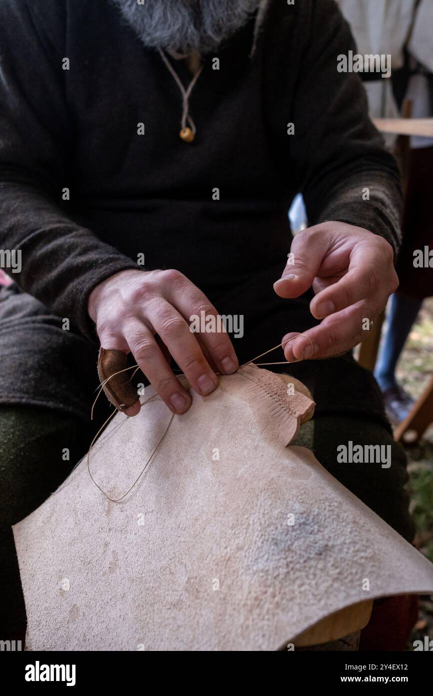 A traditional shoemaker making leather shoes in the style of the Middle ...