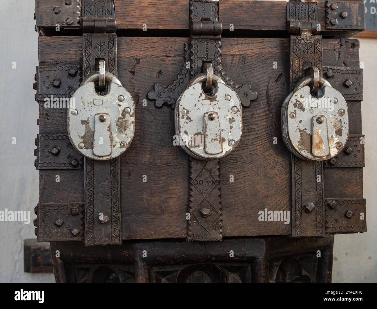 Old metal-bound wooden collection box secured by three padlocks, Holy ...