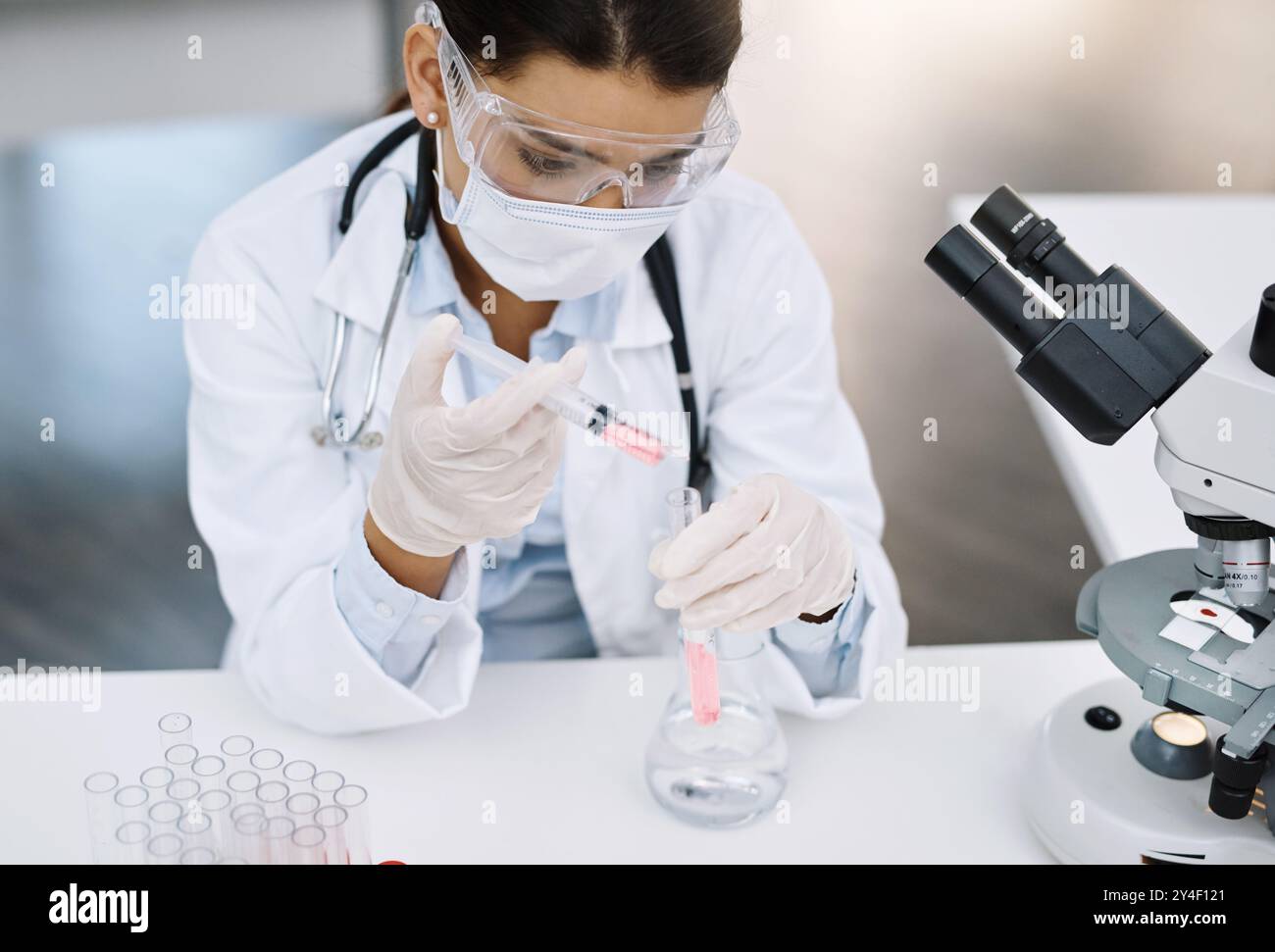Woman, scientist and test tube with syringe at laboratory, assessment ...