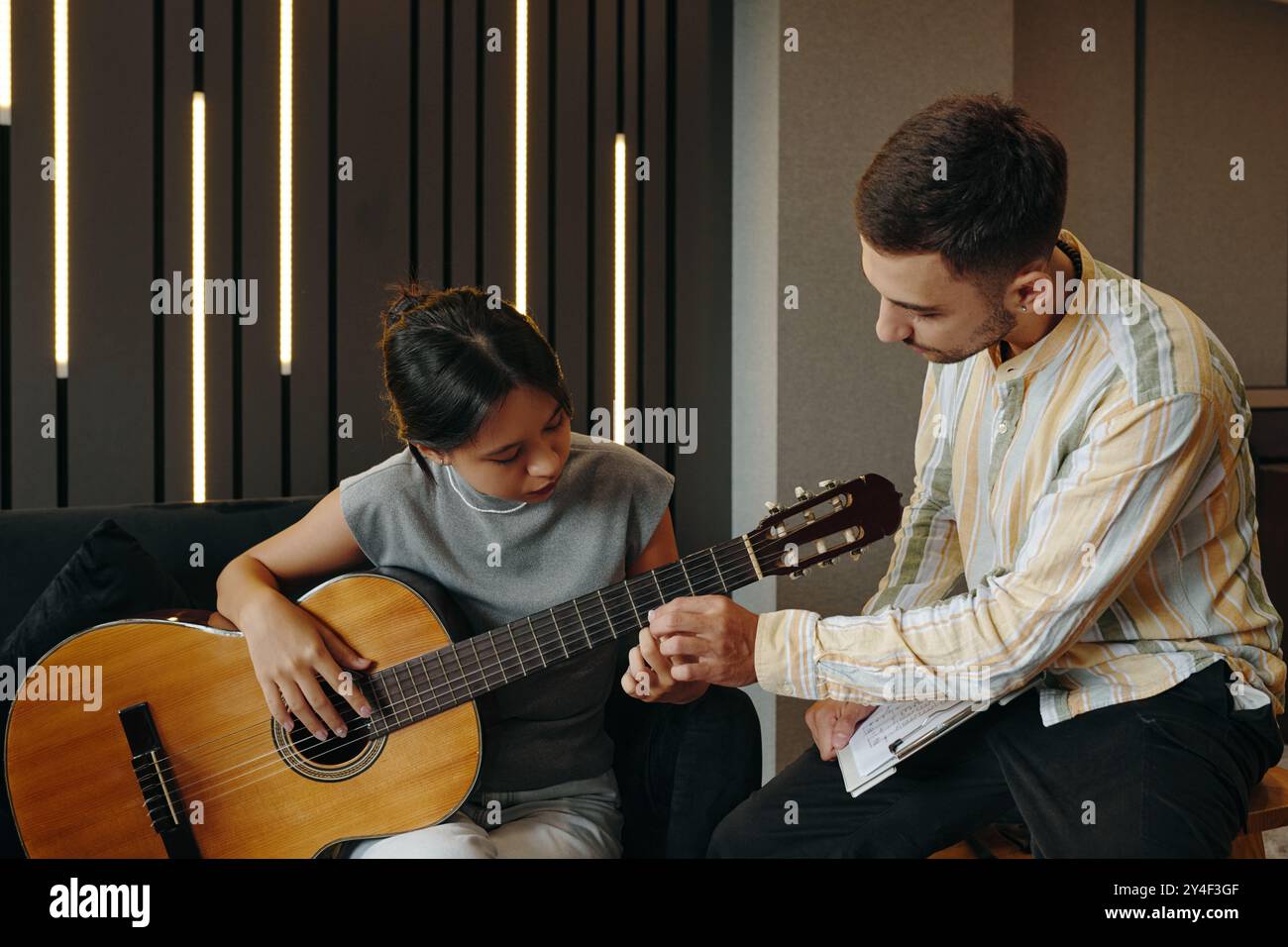 Teaching Acoustic Guitar to Young Student in Studio Stock Photo - Alamy