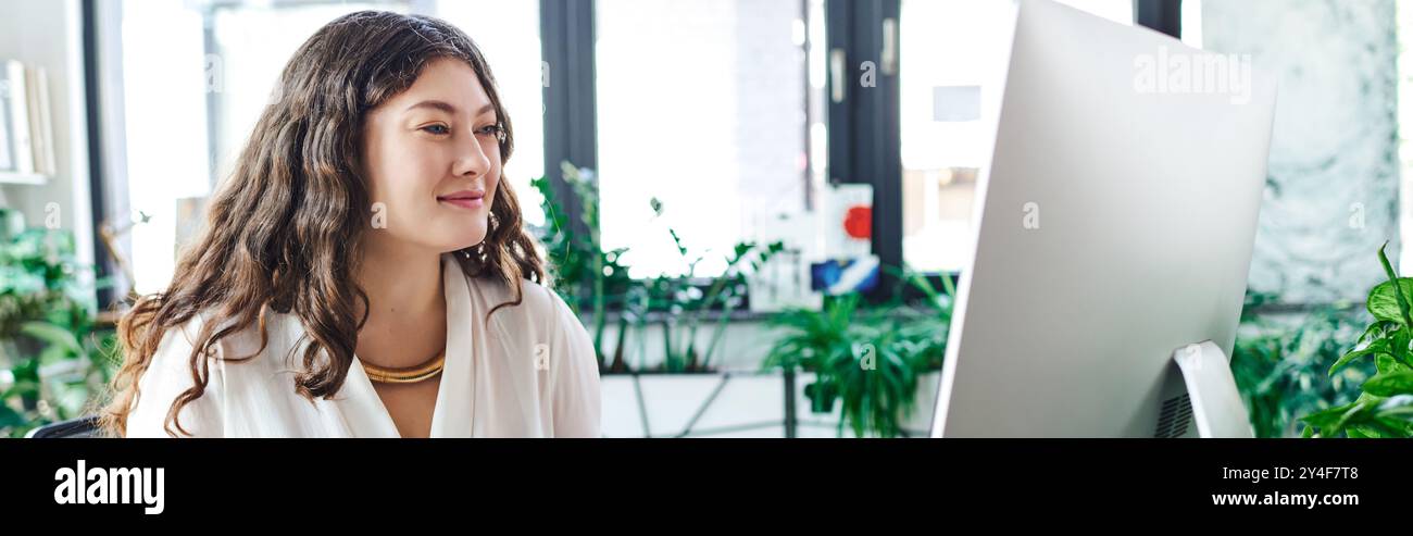 A young woman with beautiful features smiles while engaging with her ...