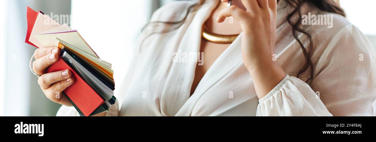 In a cozy office, a beautiful plus size woman thoughtfully explores ...
