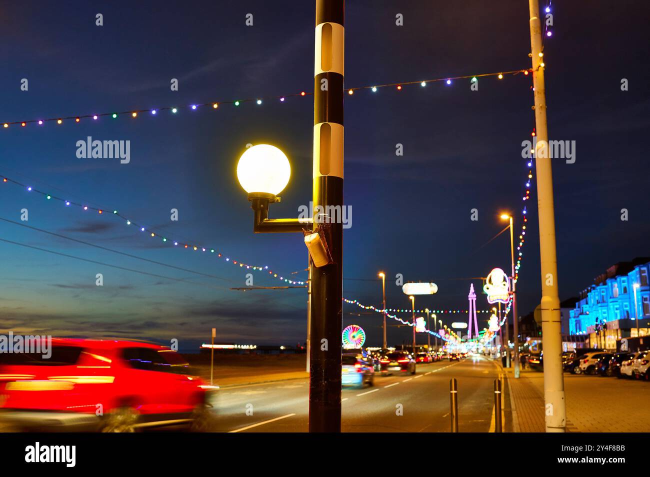 Vehicles driving through Blackpool illuminations at dusk Stock Photo ...