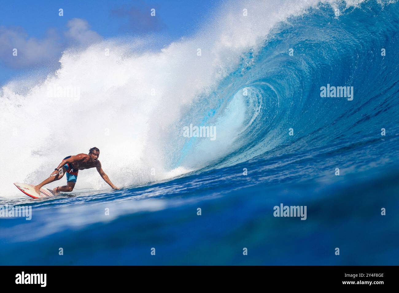 French Polynesia, Tuamotu archipelago, atoll of Faaite: surfer surfing ...