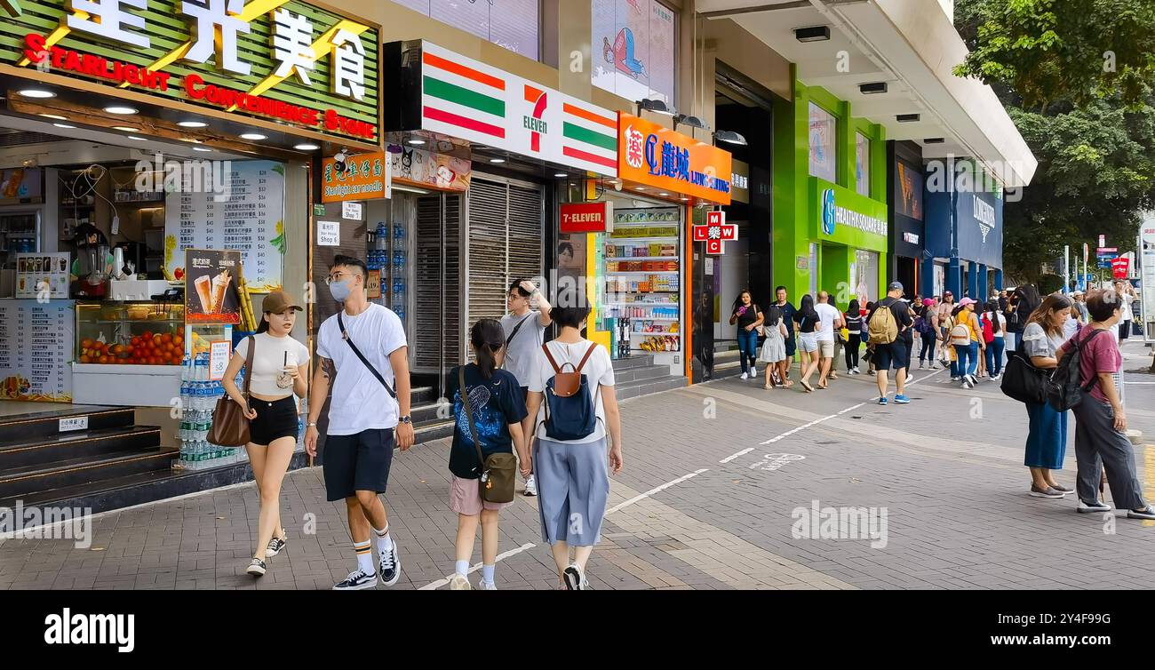 Hong Kong, China - September 18, 2024 : Pedestrians walk along a busy ...