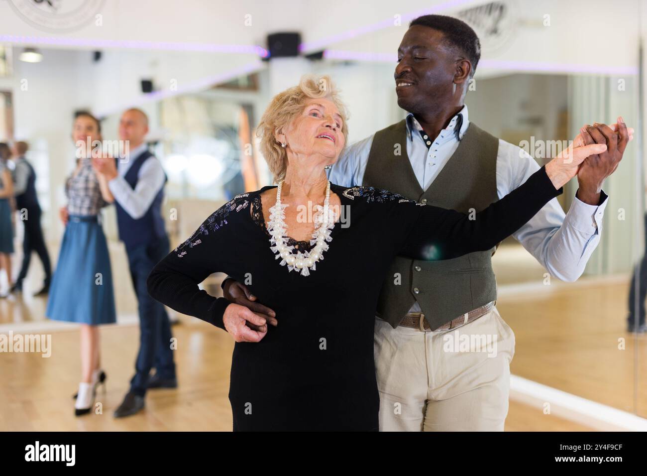 Man and mature woman learning to dance classical ballroom dance Stock ...
