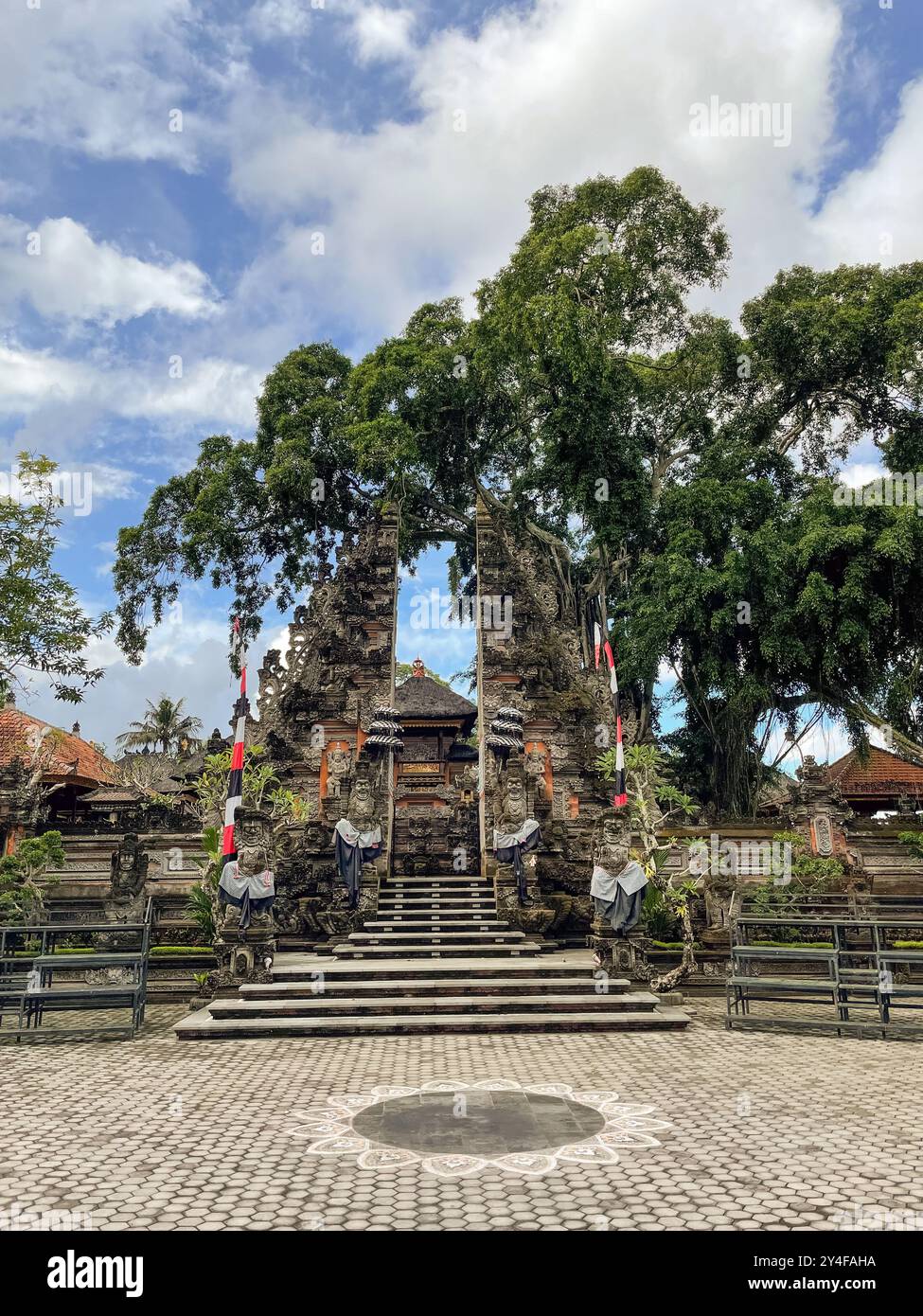 A beautiful entrance stairs in Balinese temple decorated with statues ...