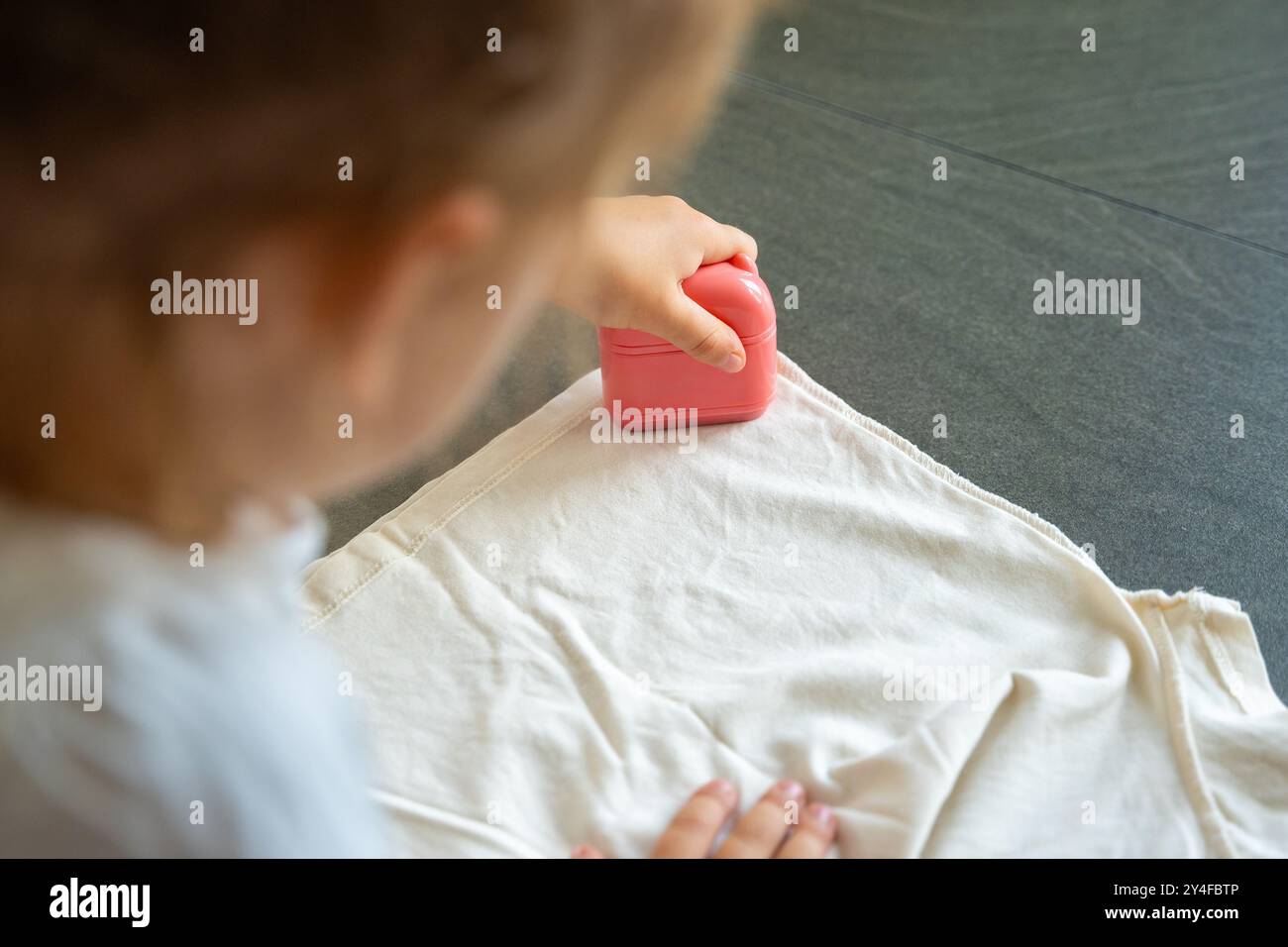 Back view of little girl with a stamp with a name for signing children ...
