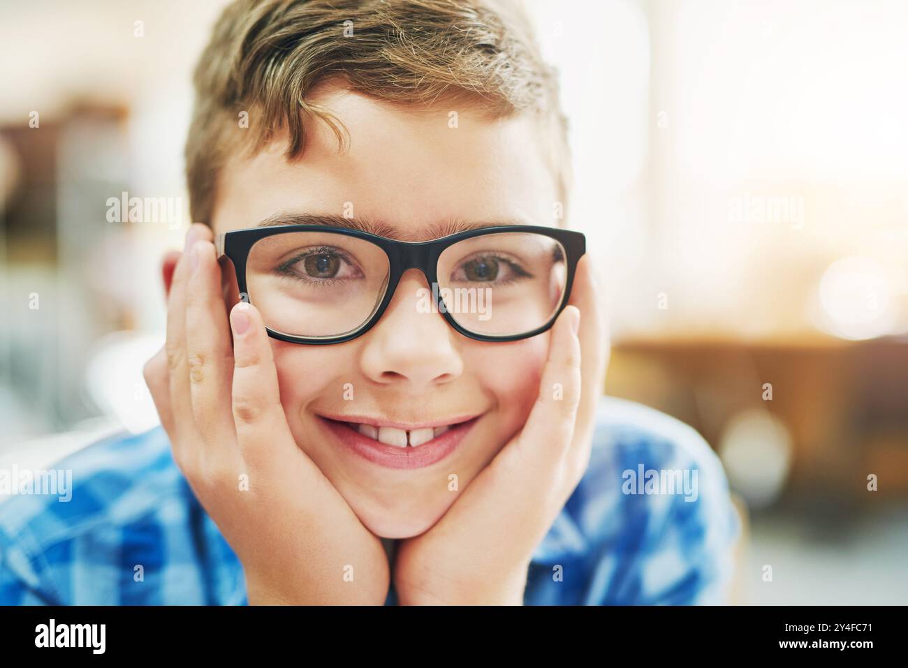 Boy, happy and portrait in classroom for learning, education and study ...
