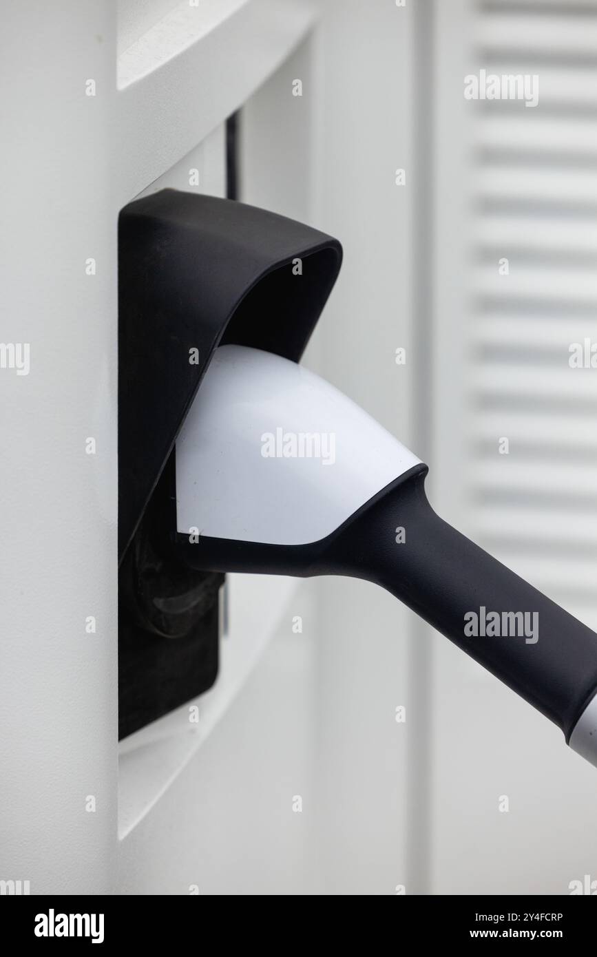 Closeup EV charger handle plugged in or connect to electric car ...