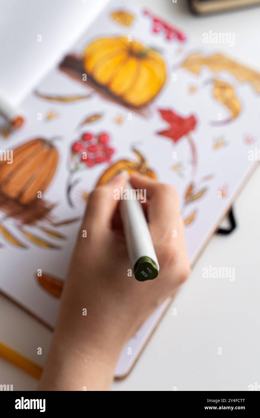 Hand holding marker while drawing Stock Photo - Alamy