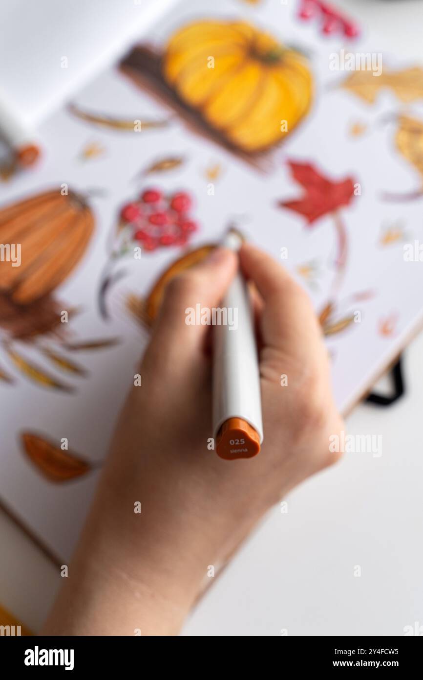 Hand holding marker while drawing Stock Photo - Alamy