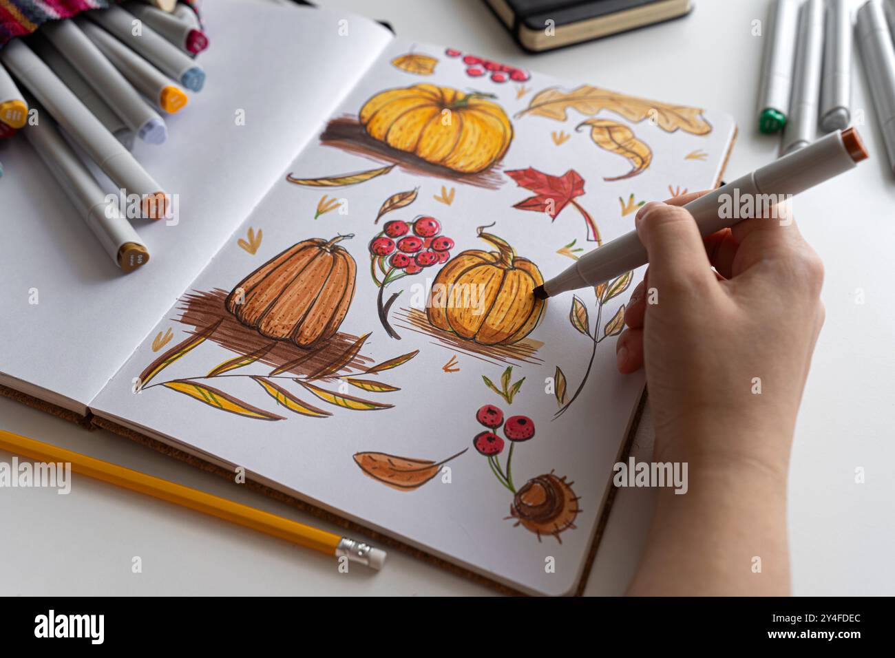 Hand holding marker while drawing Stock Photo - Alamy