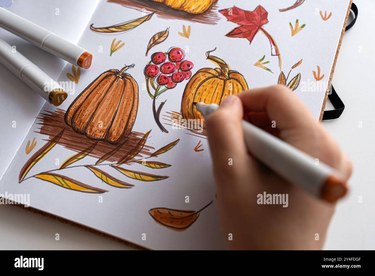 Hand holding marker while drawing Stock Photo - Alamy