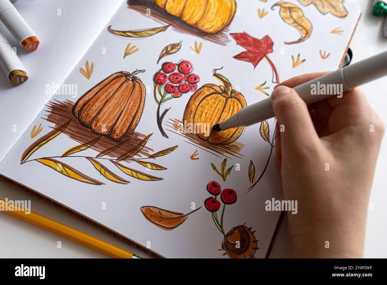 Hand holding marker while drawing Stock Photo - Alamy
