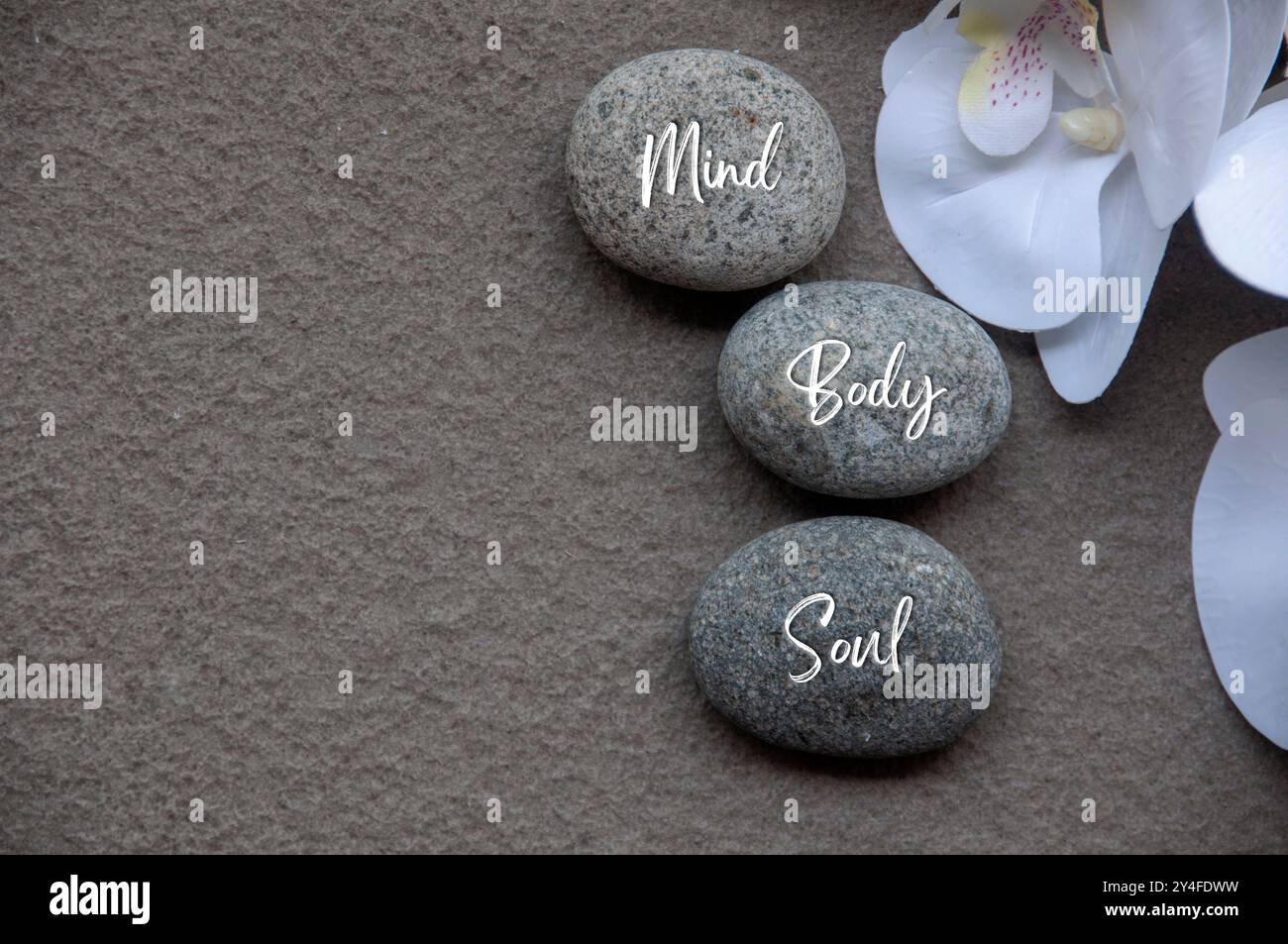 Top view of Mind, Body and Soul text on zen stones with additional ...