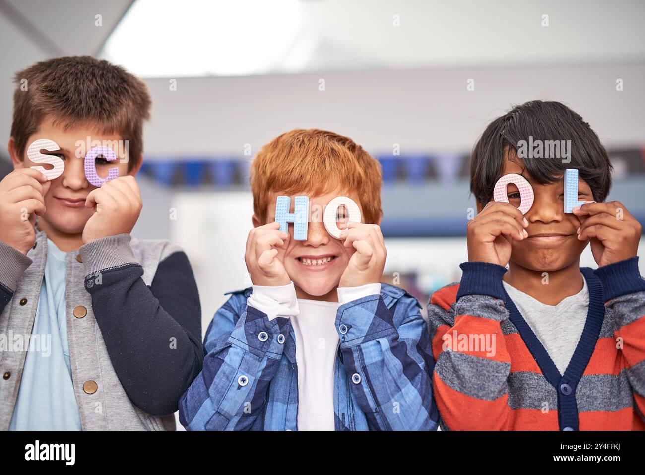 Portrait, group and kids learning letters at school on face for ...