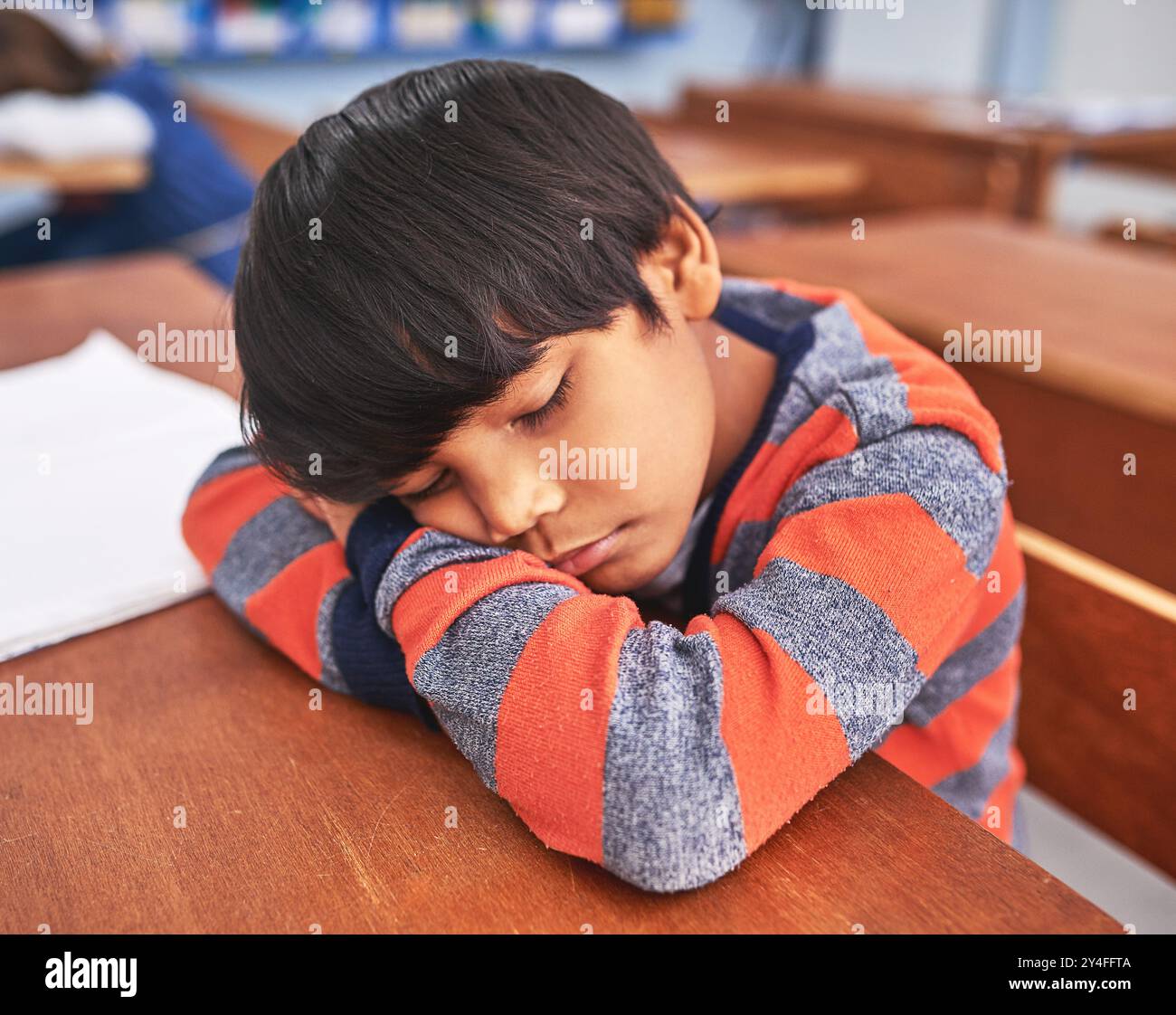 Desk, fatigue and sleeping with boy student in classroom at school for ...