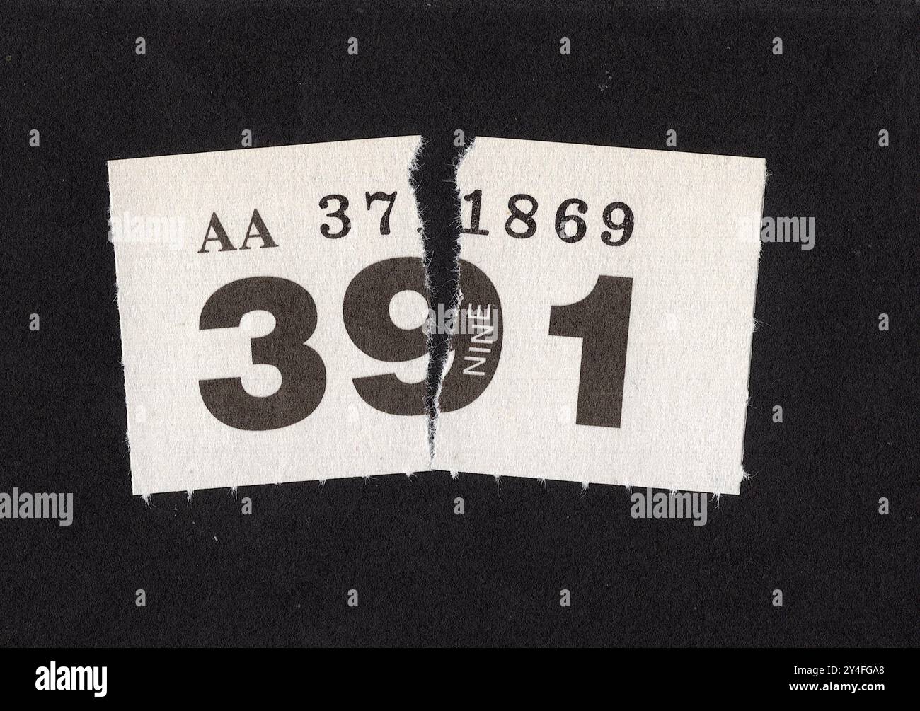 A raffle ticket torn in half on a black background Stock Photo - Alamy