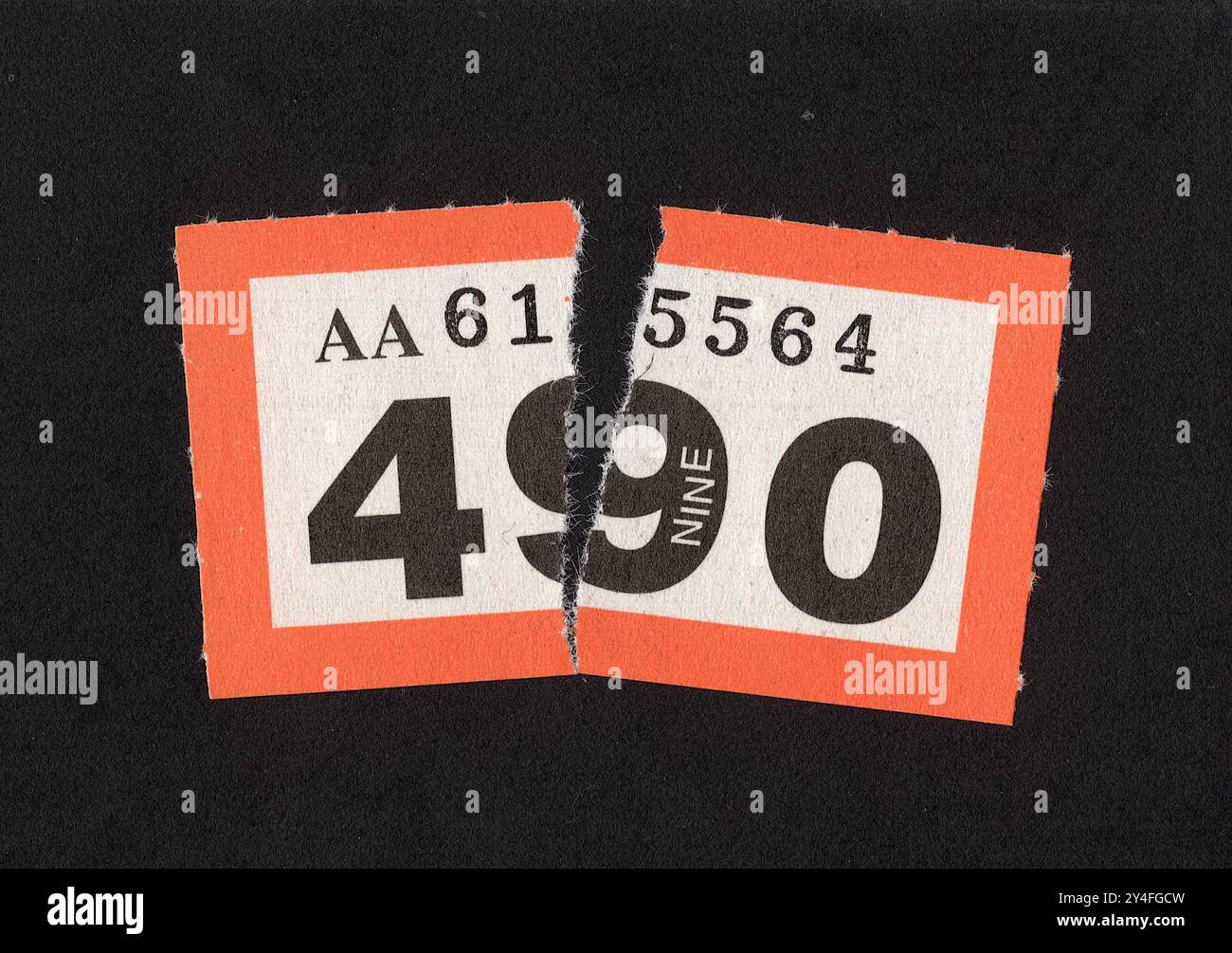 A raffle ticket torn in half on a black background Stock Photo - Alamy