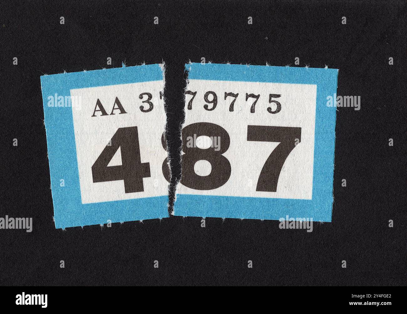 A raffle ticket torn in half on a black background Stock Photo - Alamy