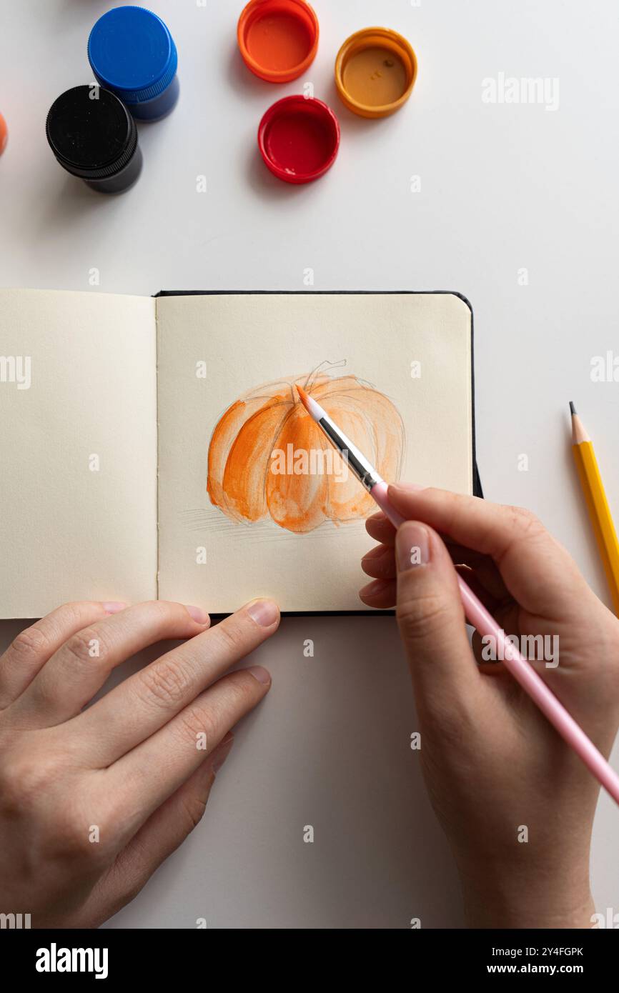 Painting a pumpkin sketch in Stock Photo - Alamy
