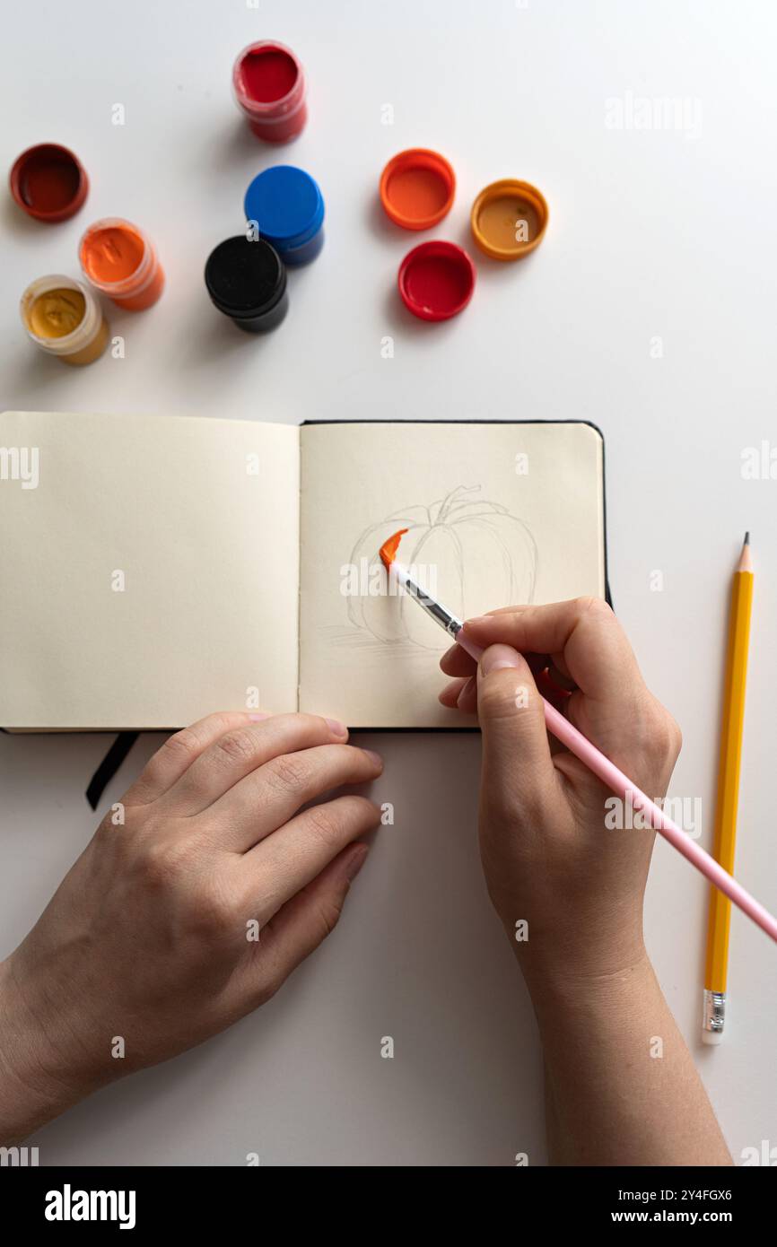 Painting a pumpkin sketch in Stock Photo - Alamy