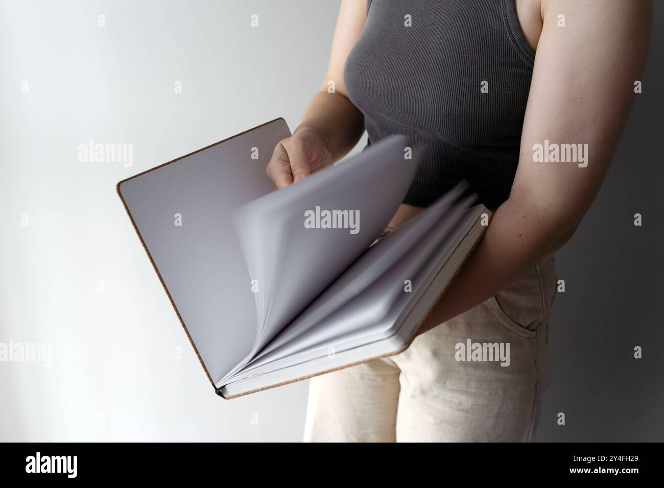 Woman flipping through blank pages Stock Photo - Alamy