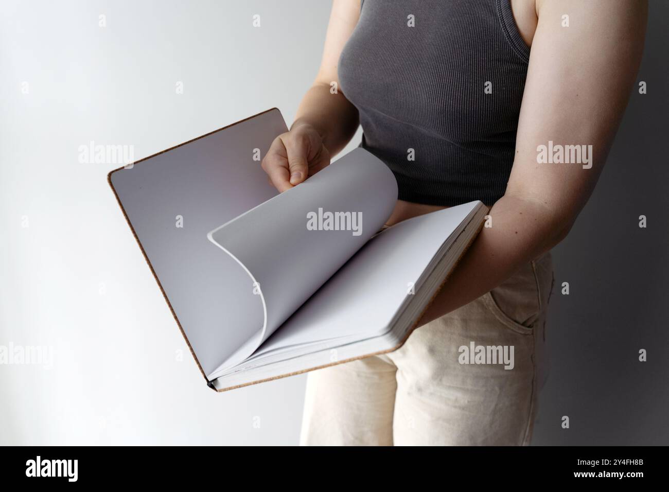 Woman flipping through blank pages Stock Photo - Alamy
