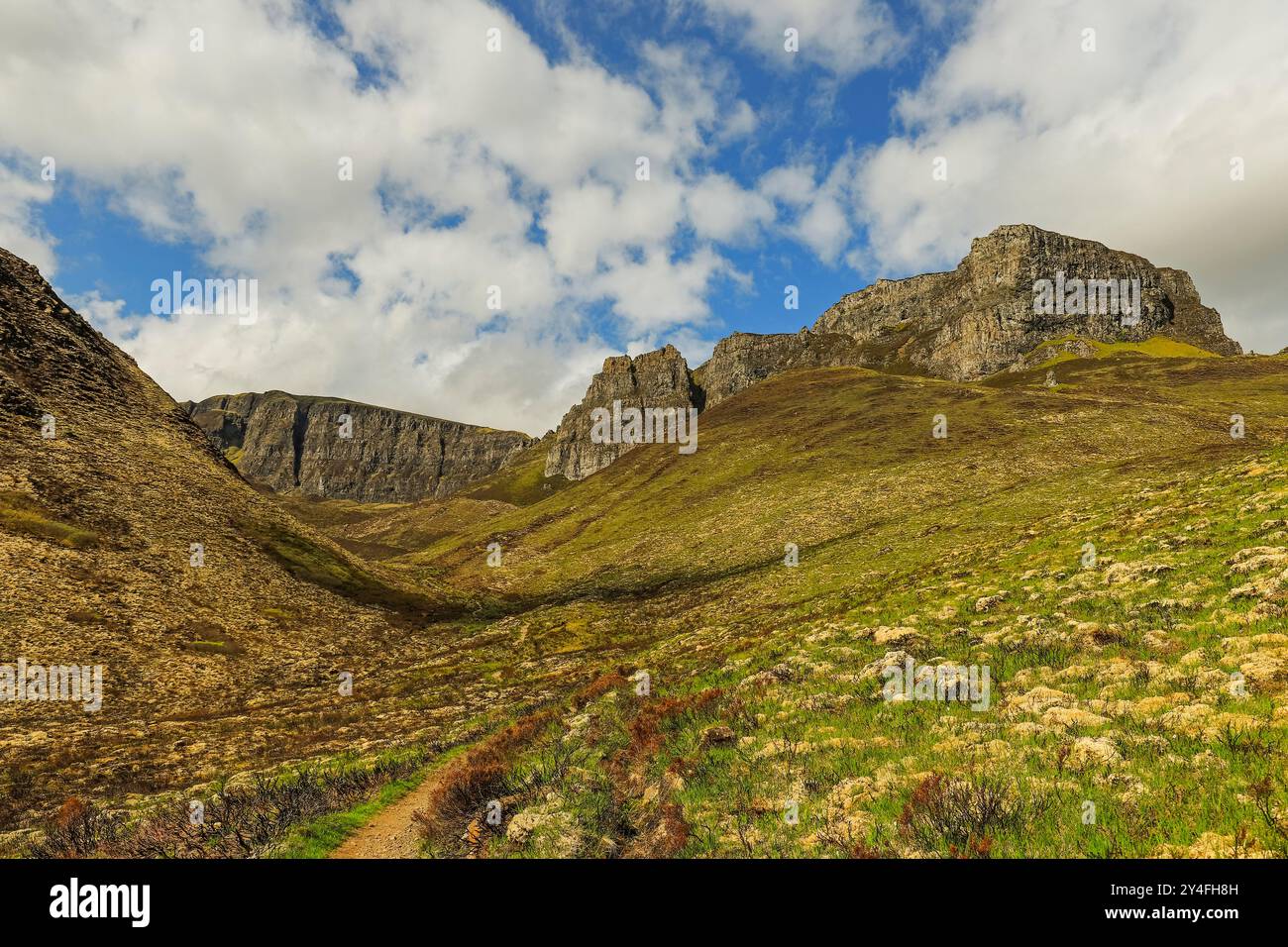 Towering basalt lava cliffs over Jurassic sediments at the Quiraing ...