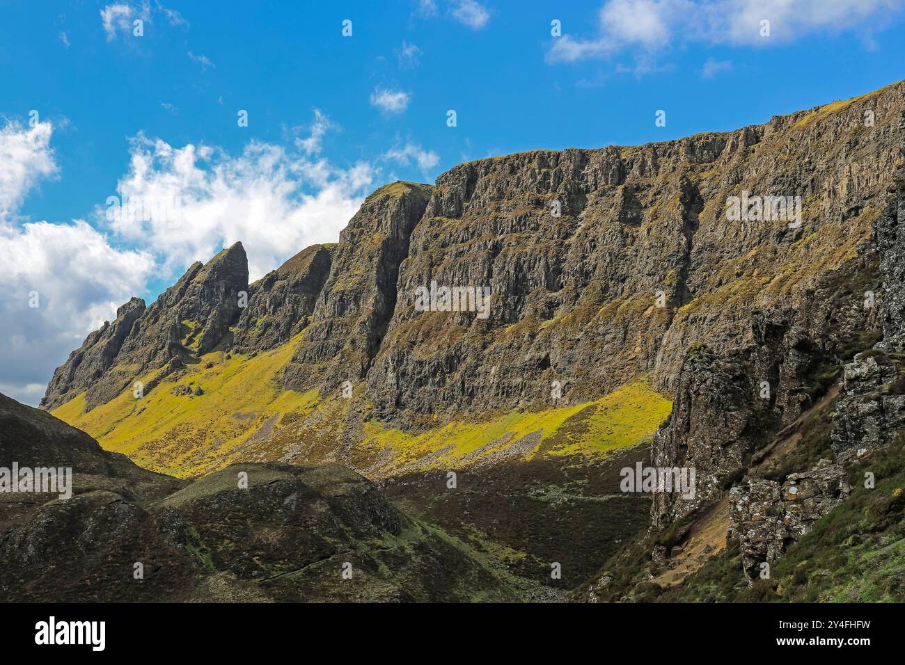 Towering basalt lava cliffs over Jurassic sediments at the Quiraing ...