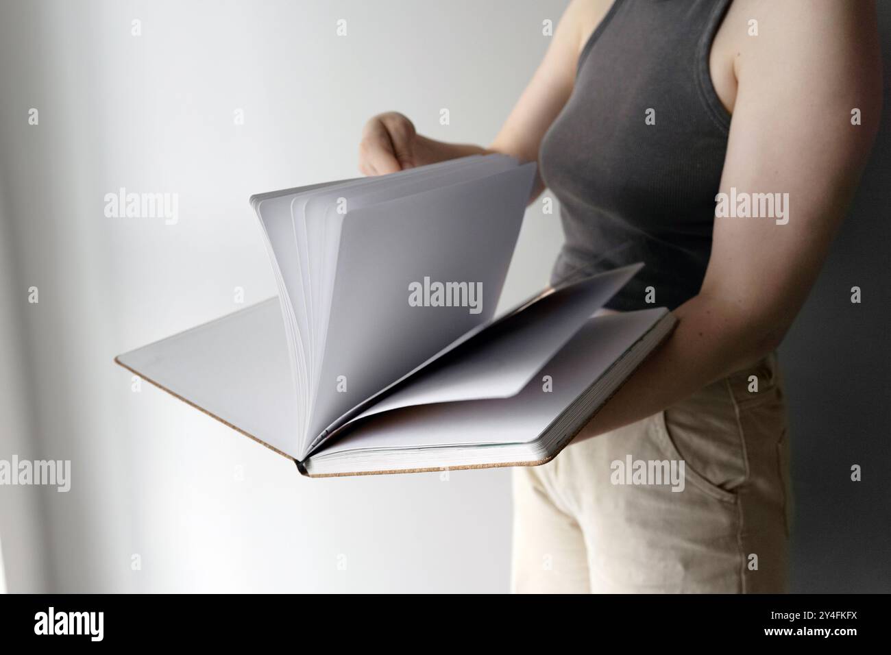 Woman flipping through blank pages Stock Photo - Alamy