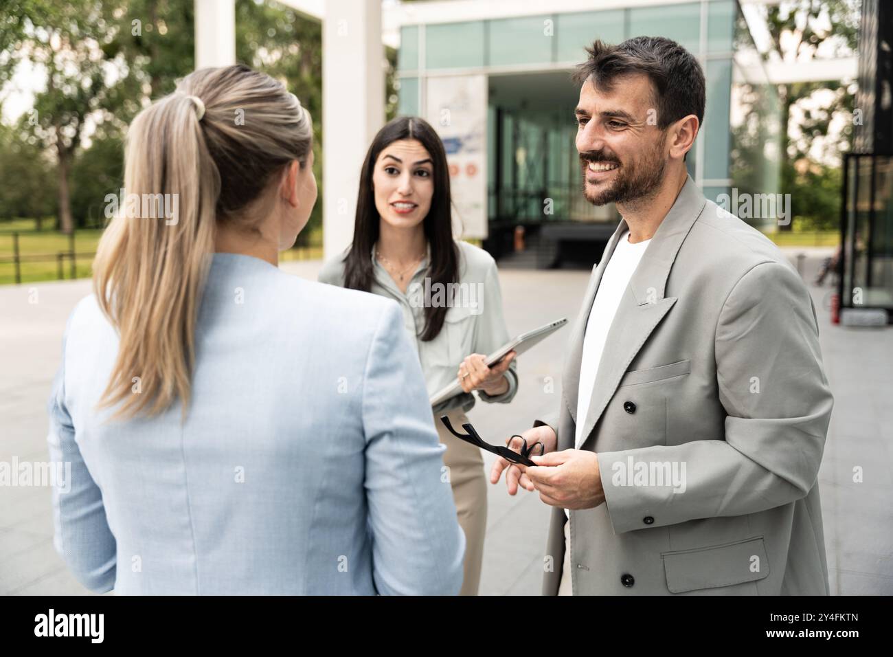 Group of young successful professional business people standing outside ...