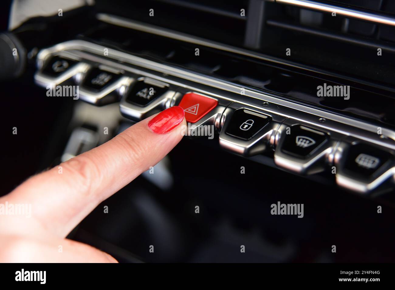 Female pressing red triangle car hazard warning button Stock Photo - Alamy