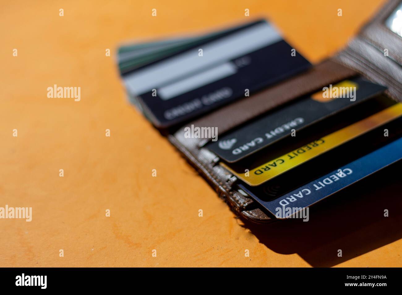 collection of credit cards of various colors in orange isolated wallet ...