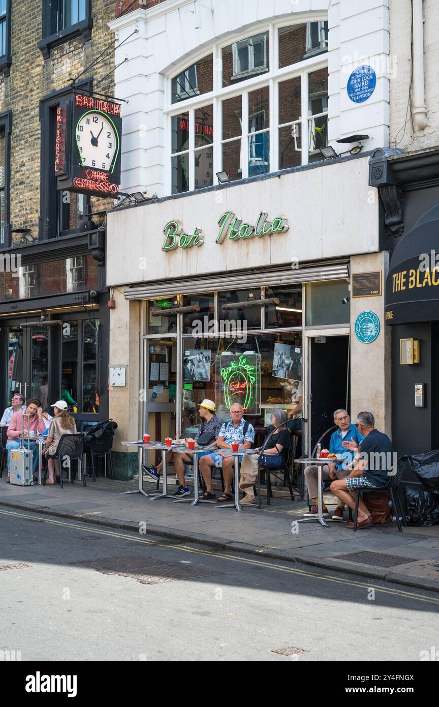 People enjoying food and drink seated at pavement tables outside Bar ...