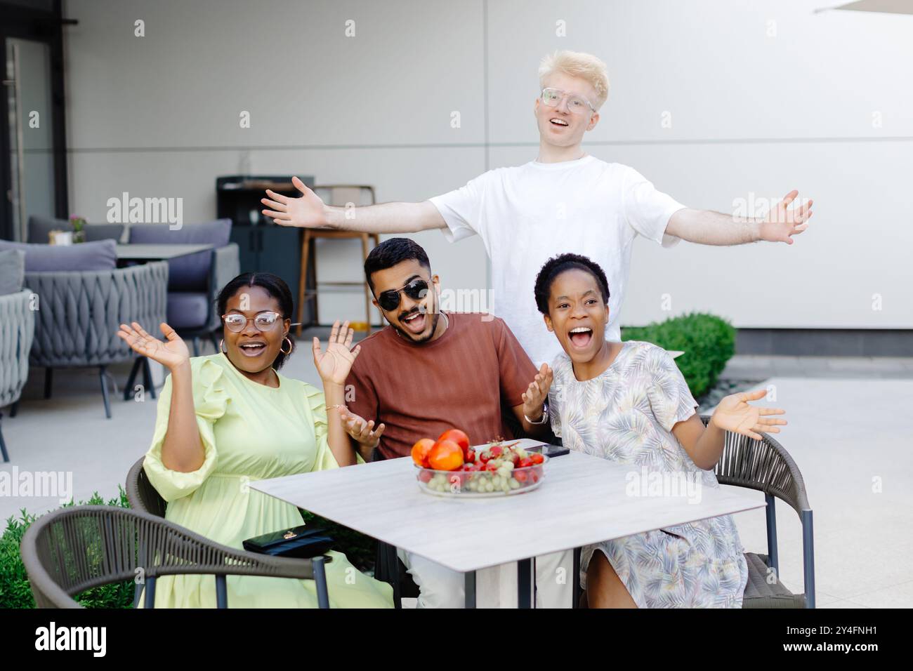 Multinational friends having fun in outdoor cafe in summer time Stock ...