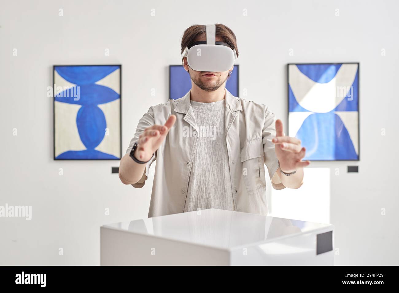 Minimal portrait of man wearing VR while interacting with invisible ...