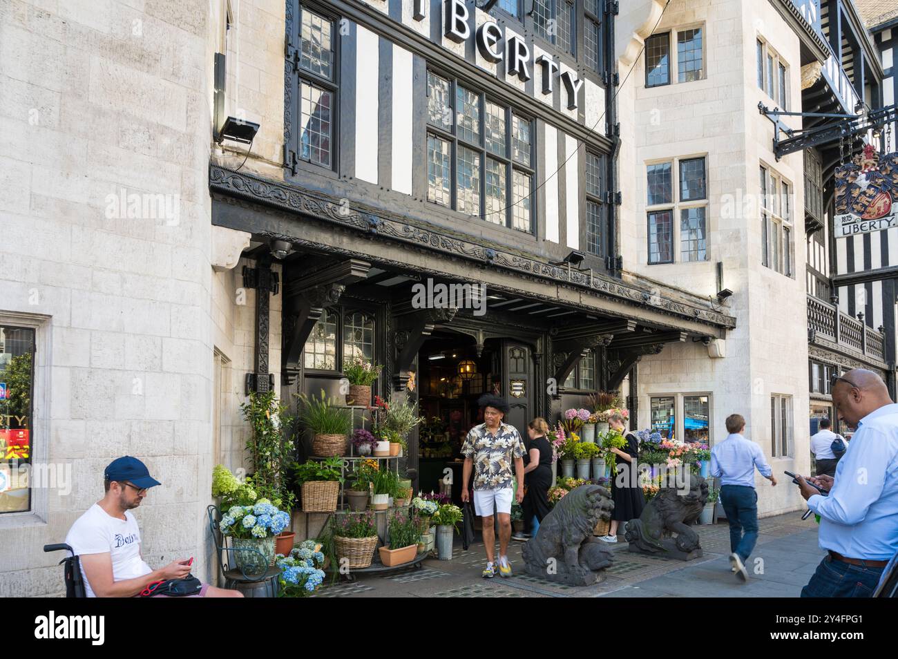 People shopping pass in and out of main entrance to Liberty's an iconic ...