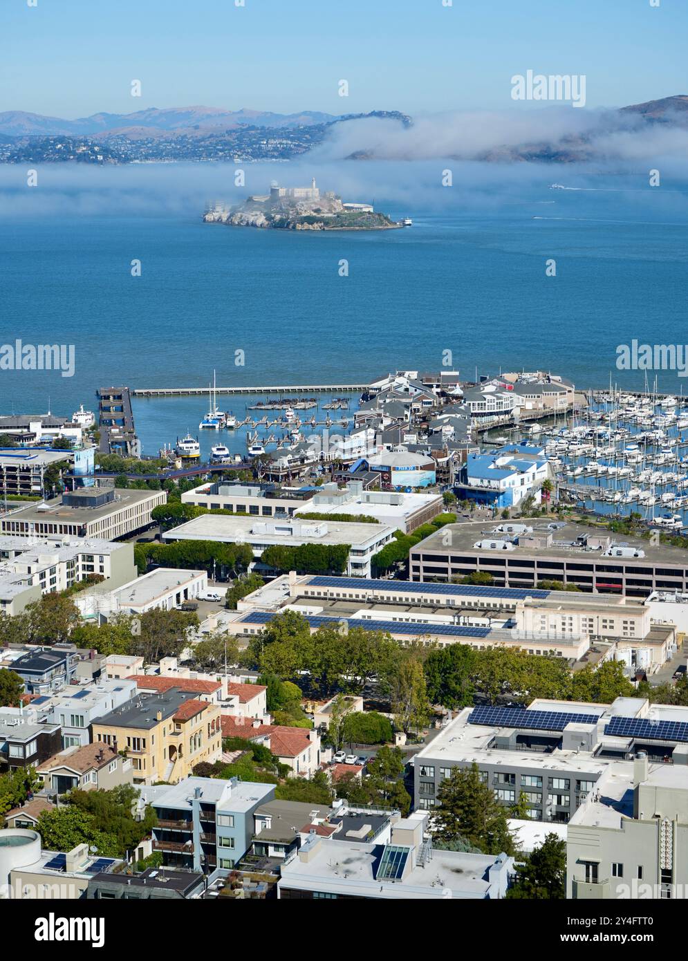 Pier 39 area marina with Alcatraz Island under a misty sky Stock Photo ...