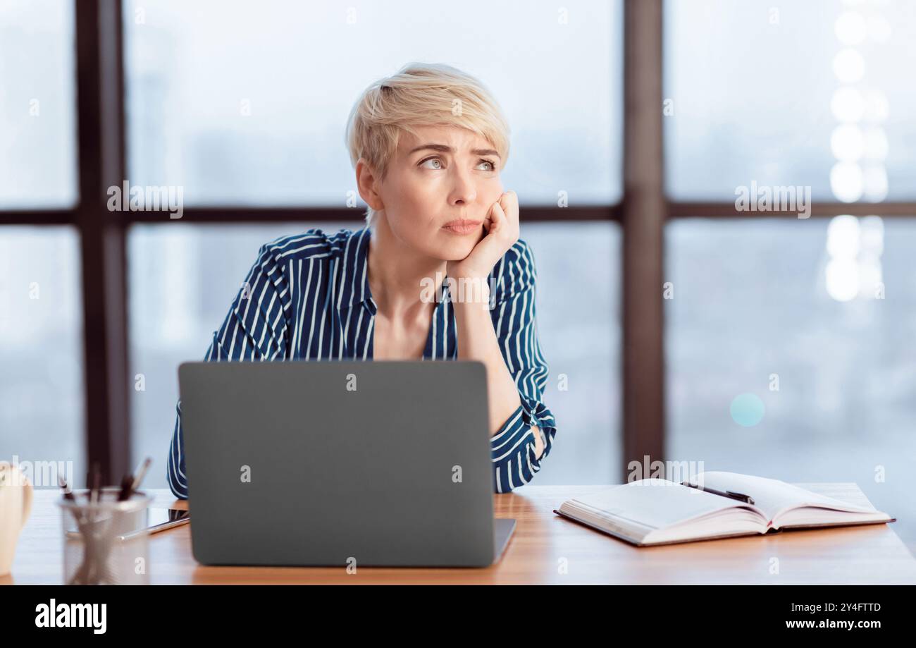 Unmotivated lady sitting workplace hi-res stock photography and images ...