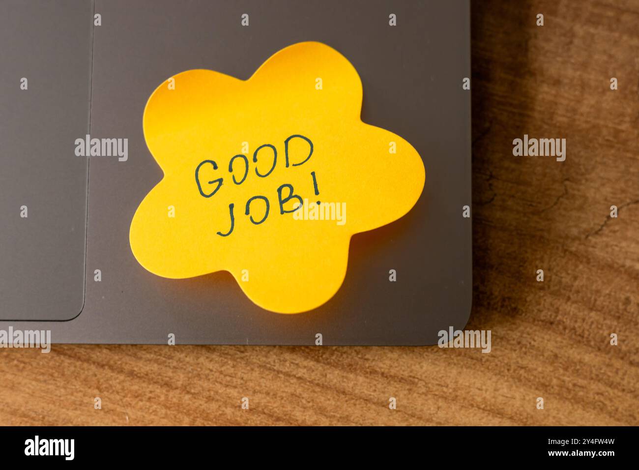 Bright yellow sticky note with cheerful message on a laptop in a cozy ...