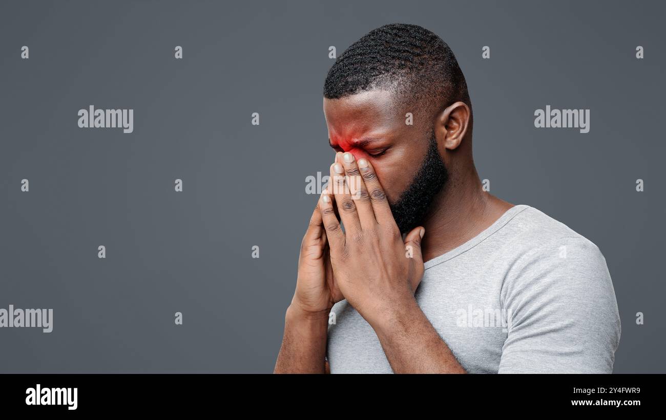 Exhausted black guy suffering from antritis, rubbing nose bridge Stock ...