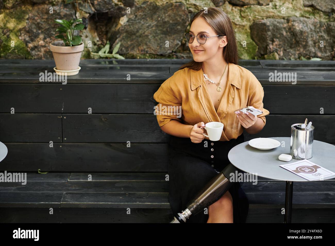A confident young woman sits in a cozy cafe, sipping coffee and ...