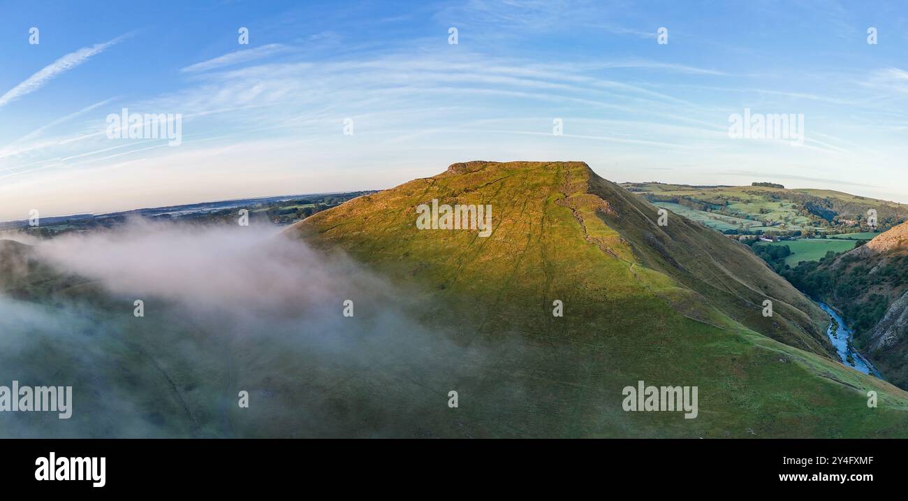 The rising sun lights up the side of Thorpe cloud as some mist loves ...