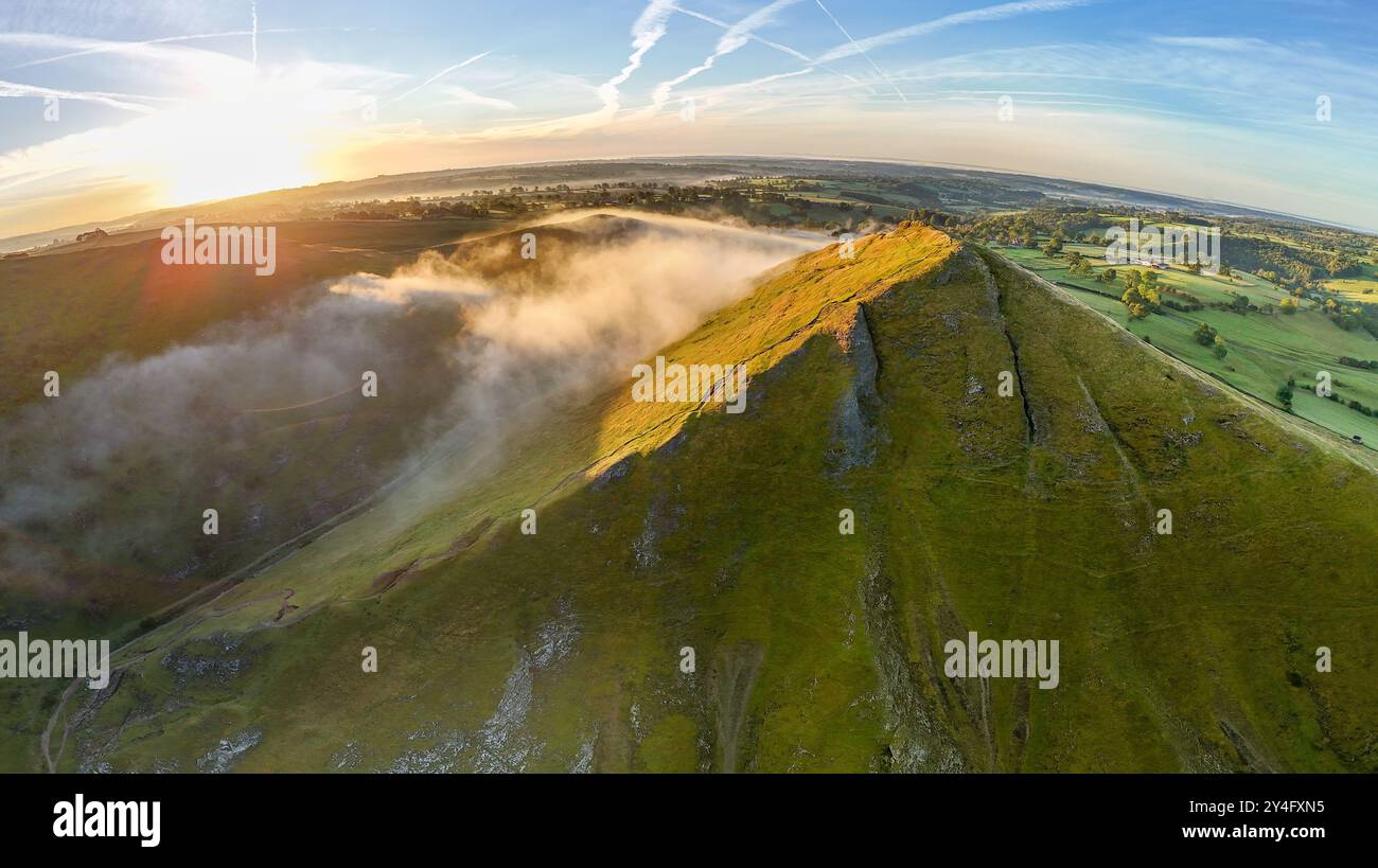 The rising sun lights up the side of Thorpe cloud as some mist loves ...
