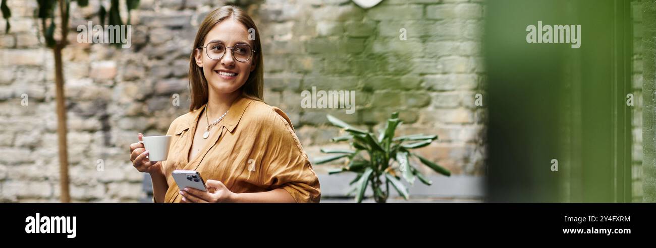 A young woman with smartphone smiles while sipping coffee, engaging in ...