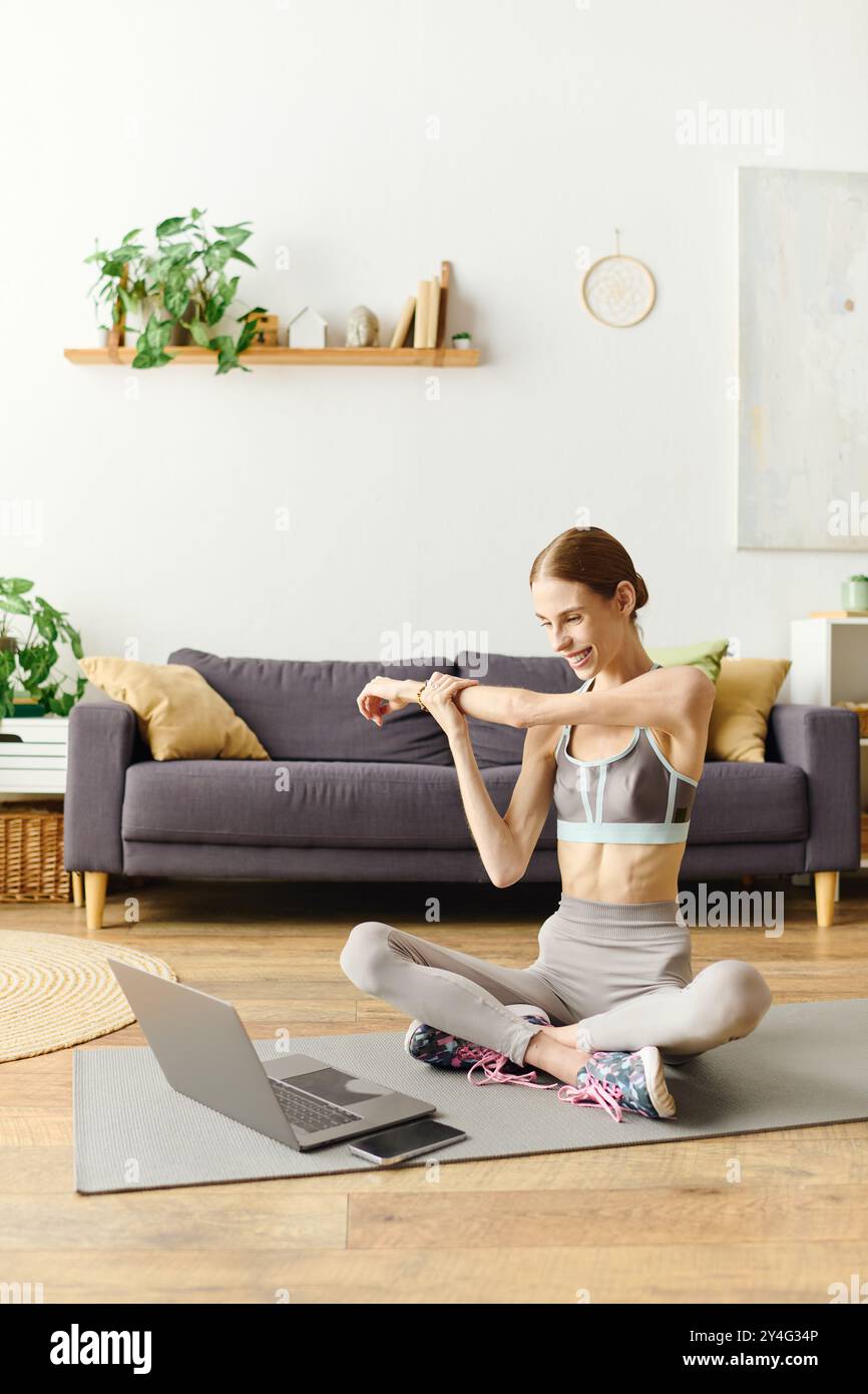 A young woman with anorexia practices her workout routine at home, focusing on her health ...