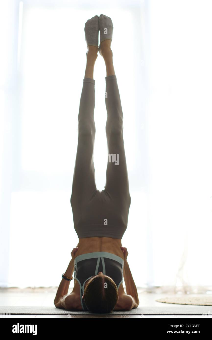 With legs raised high, a young woman with anorexia dedicates her time ...