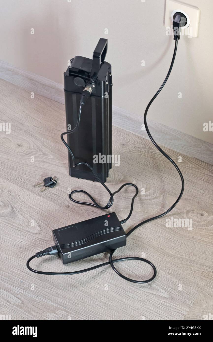 Charging bicycle battery from mains electricity in house. Socket in ...